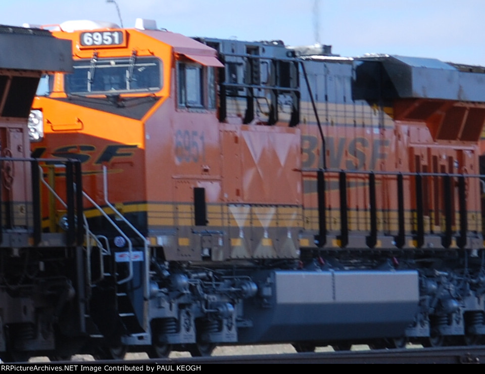 BNSF 6951 a little blurry in this shot heads west as a #2 unit.